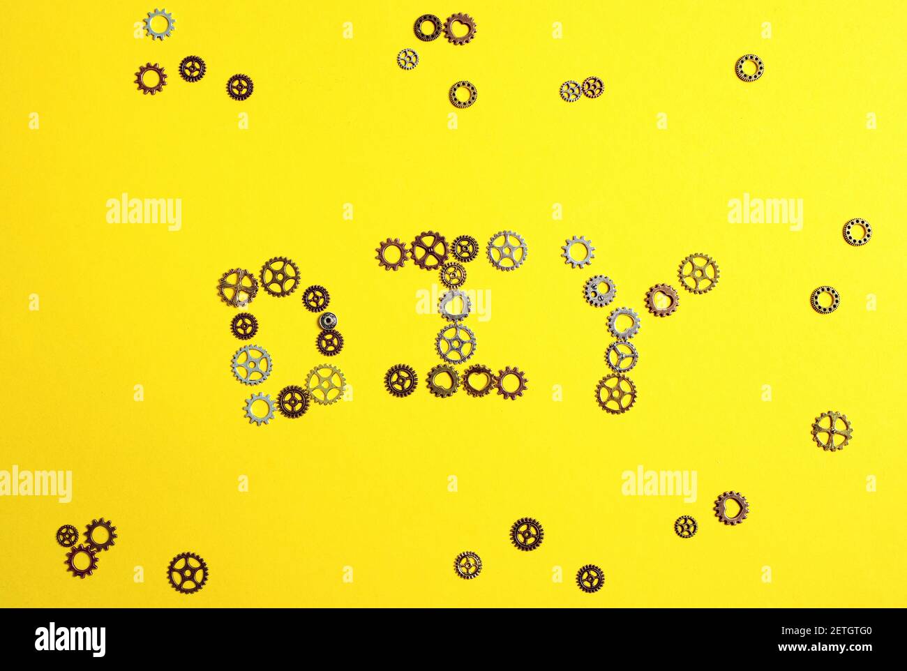 DIY abbreviation made of gears on yellow background. Do it yourself ...