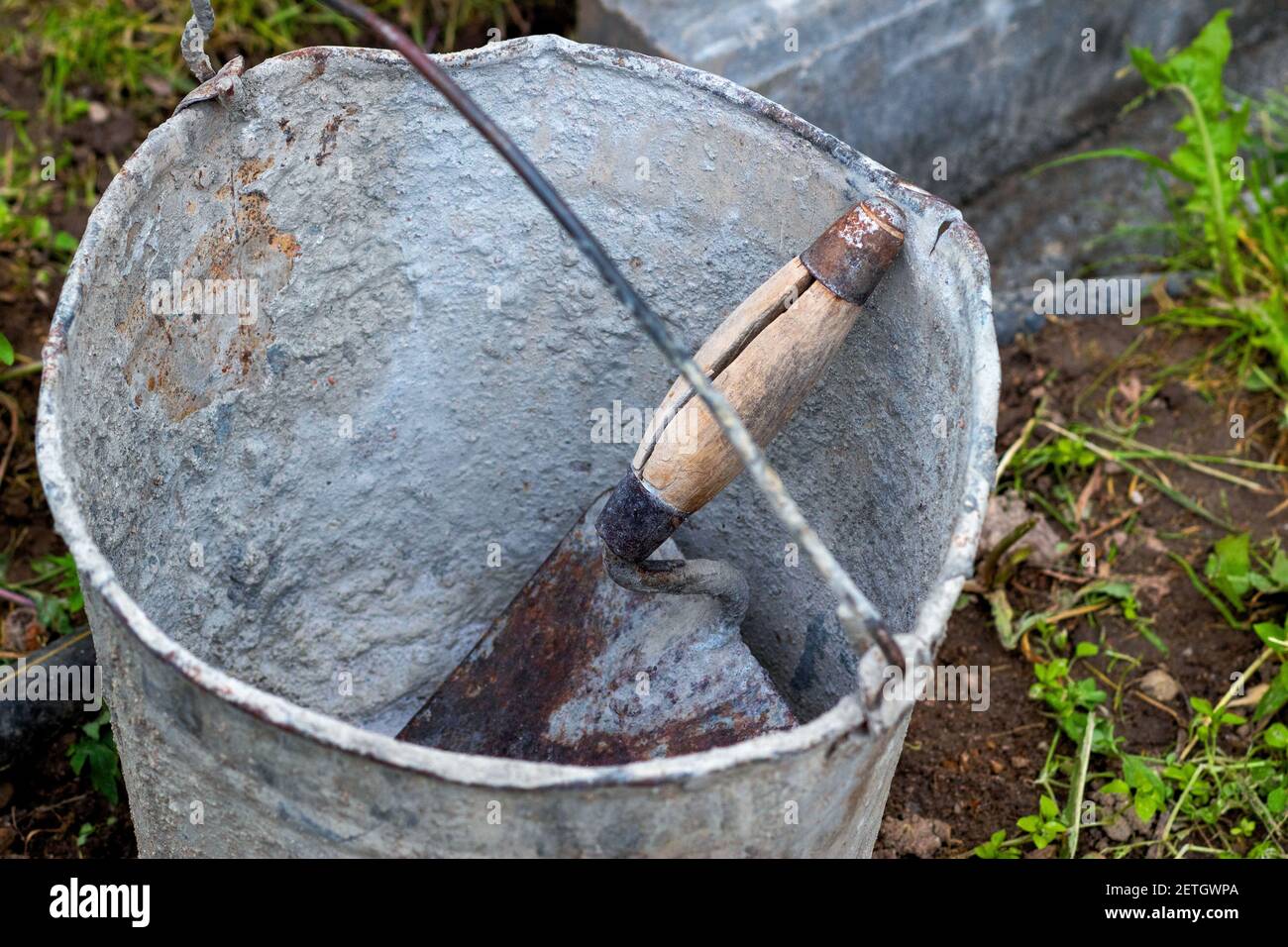 The use of cement for construction. Knead the cement in a bucket. The ...