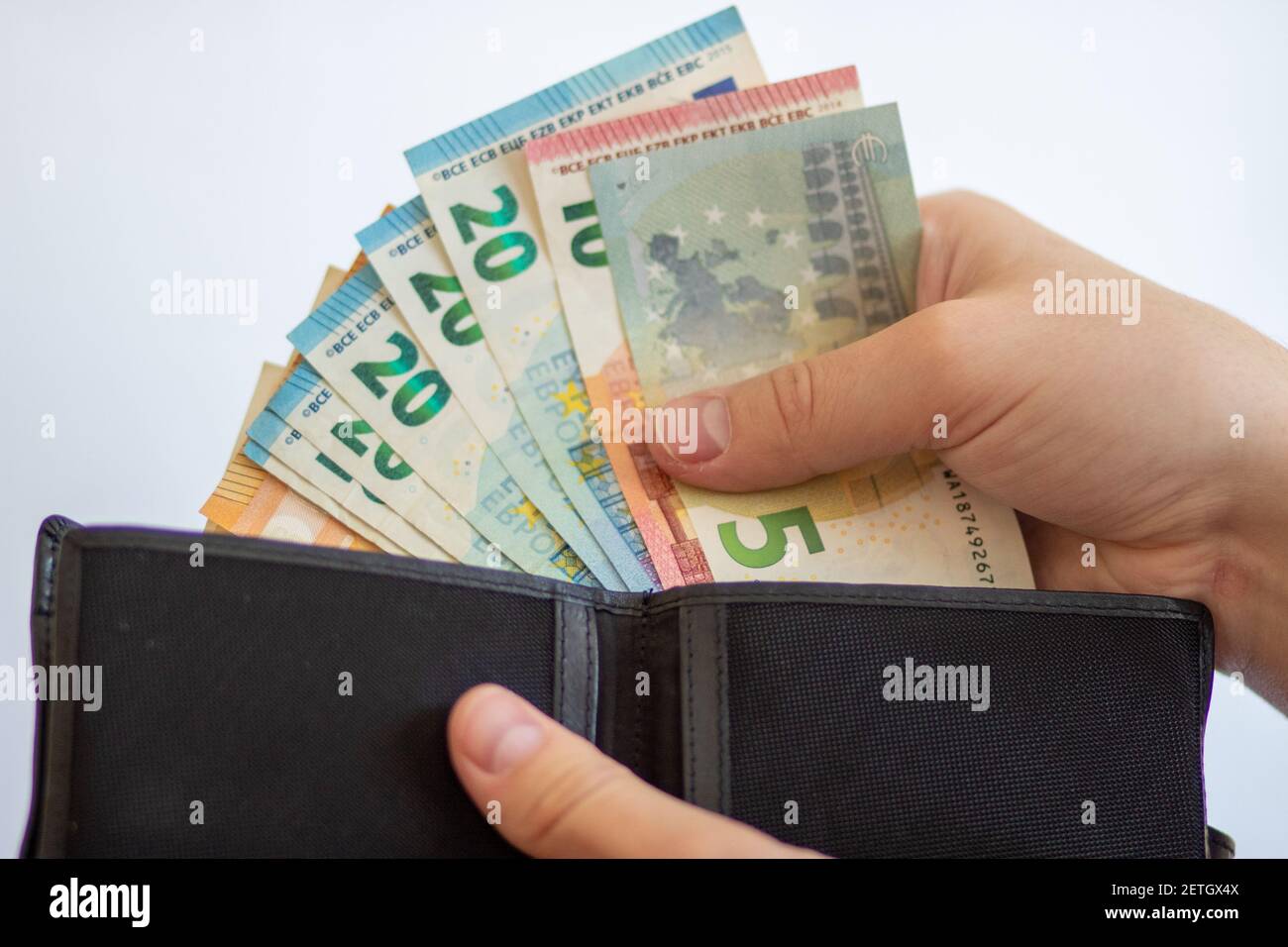 Pay in euros. Get euros from your wallet. Euro bills on a white ...