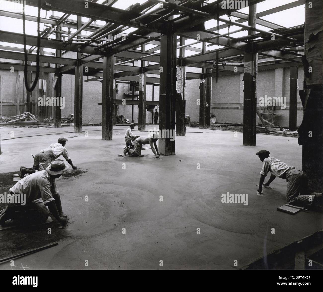 Photograph of Workers Finishing the Floor of a Stack Area in the ...