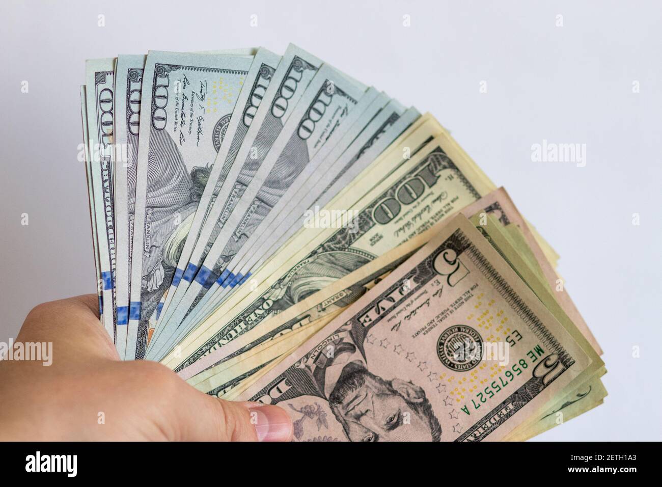 Pay with dollars. Get dollars out of your wallet. Dollar bills on a ...