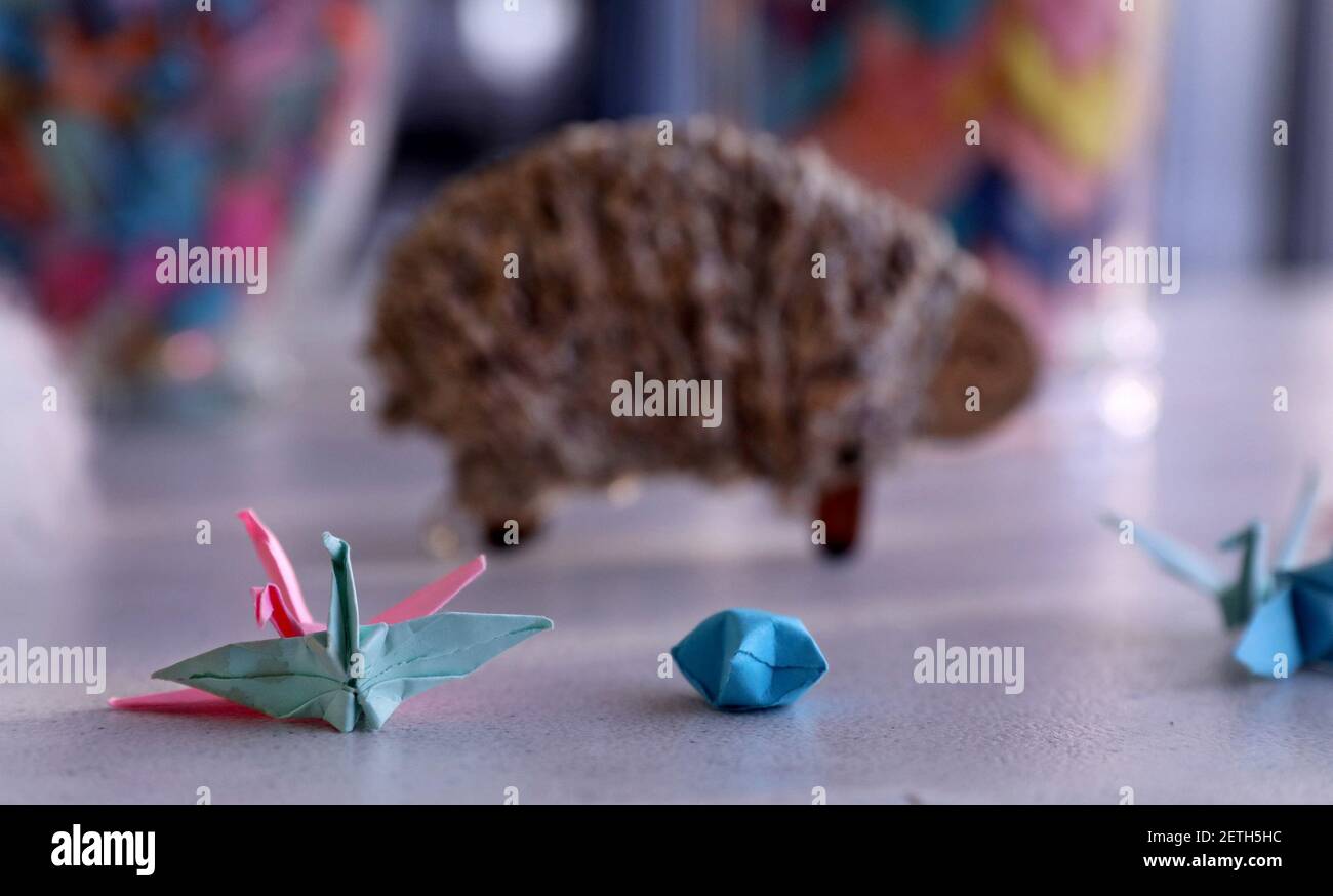 Origami cranes rest among other artwork created by immigrant children ...