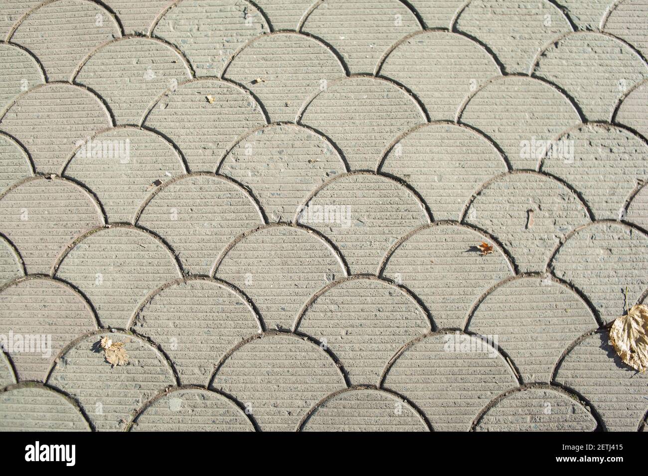 Texture of stone paving stones. Cobblestone arched pavement road at the ...