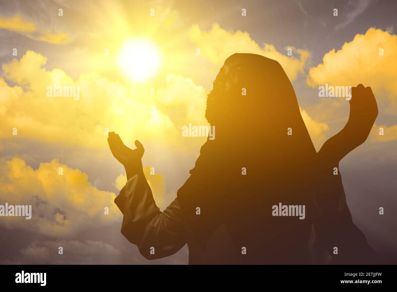 Jesus Christ praying to god with sunlight background Stock Photo - Alamy