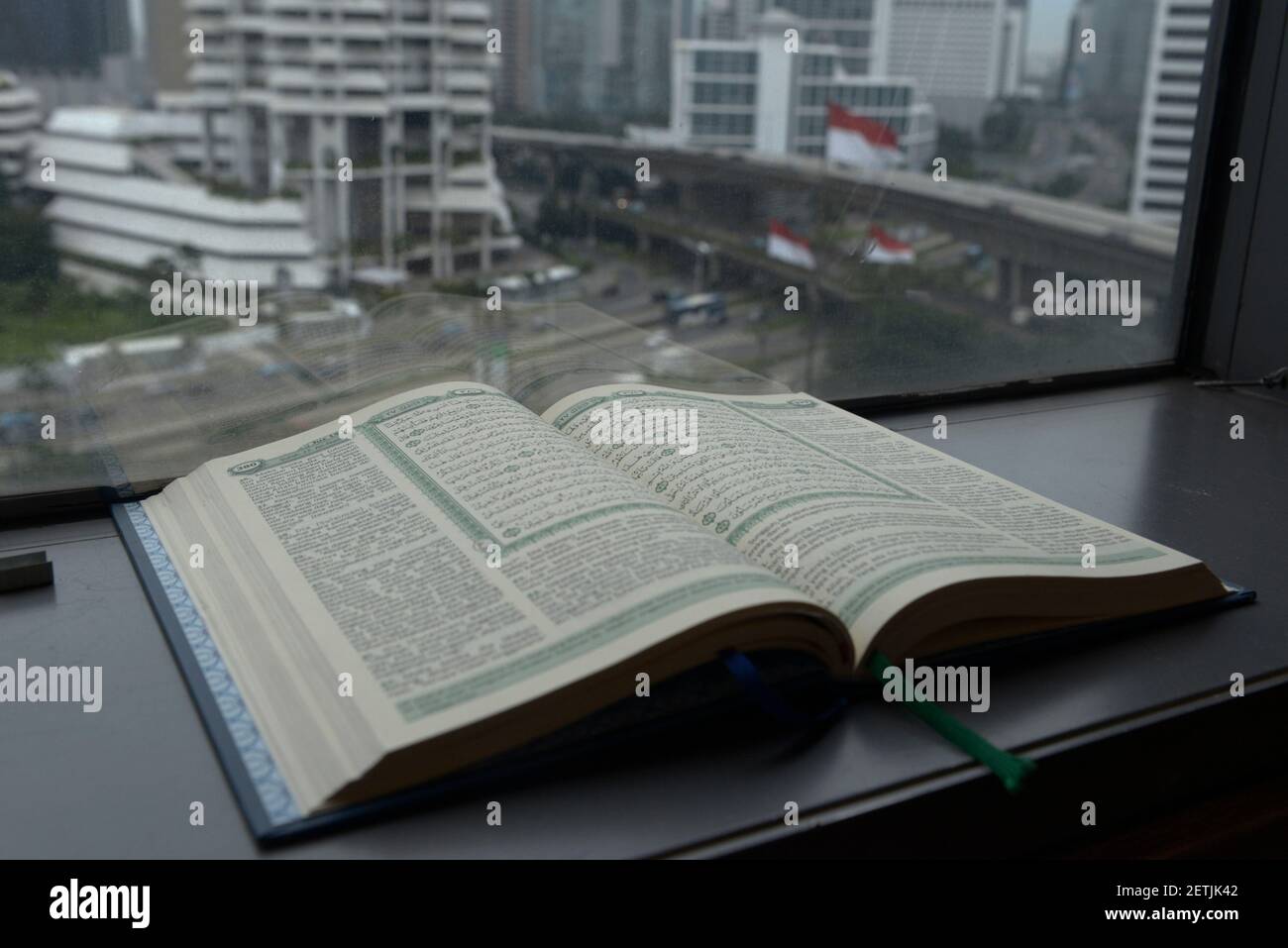 Quran open beside the window with cityscapes background Stock Photo - Alamy
