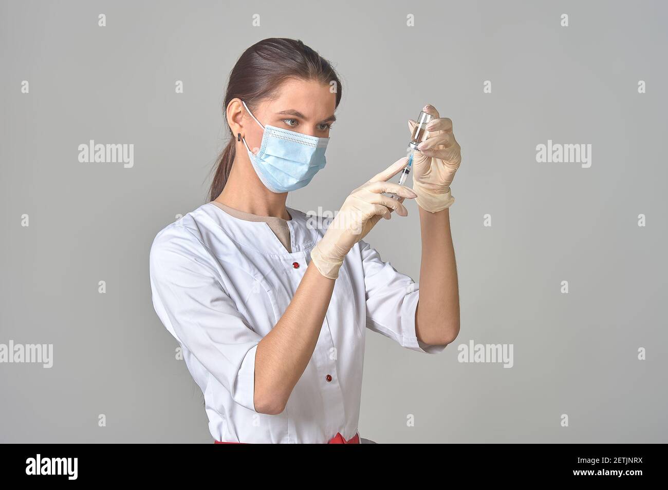 A nurse taking medicine into a syringe from a bottle close-up Stock ...
