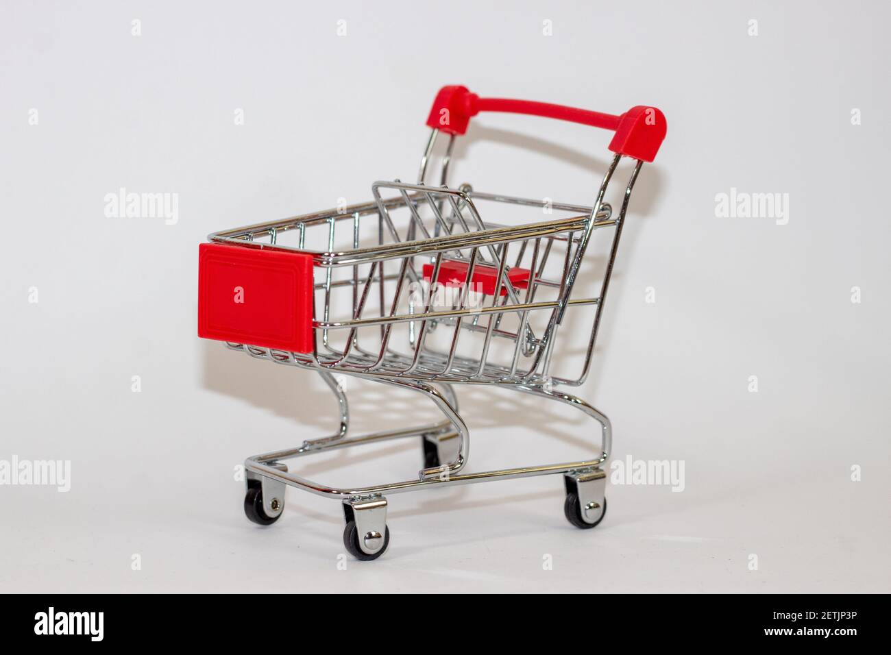 Red toy cart on white isolated background Stock Photo - Alamy