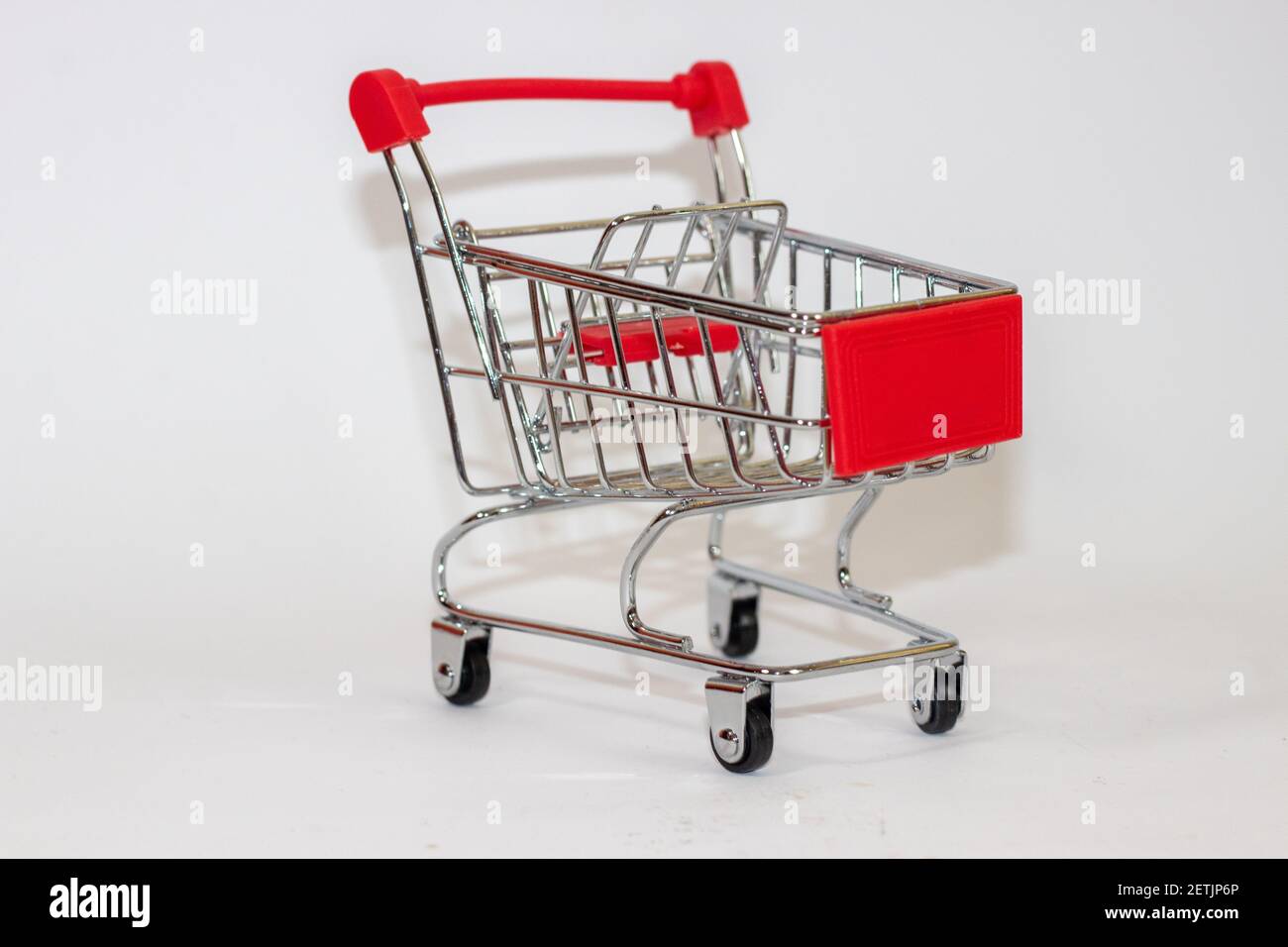 Red toy cart on white isolated background Stock Photo - Alamy