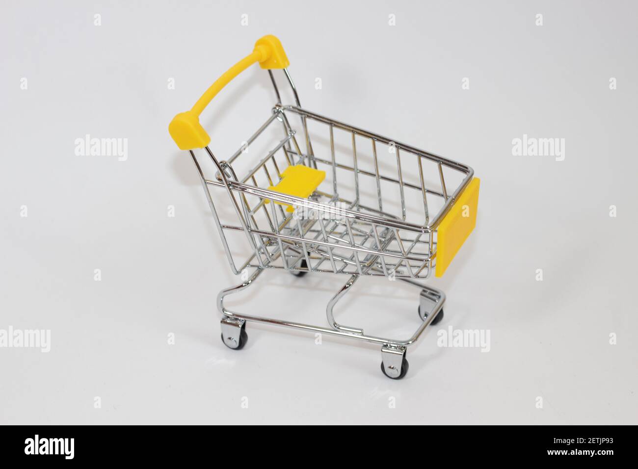 Yellow toy cart on white isolated background Stock Photo - Alamy