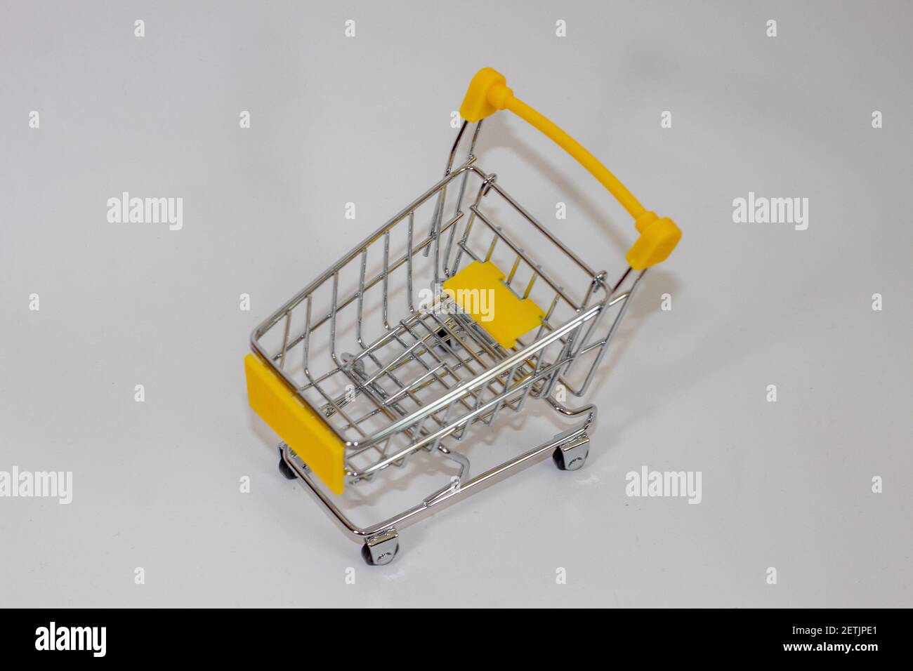 Yellow toy cart on white isolated background Stock Photo - Alamy