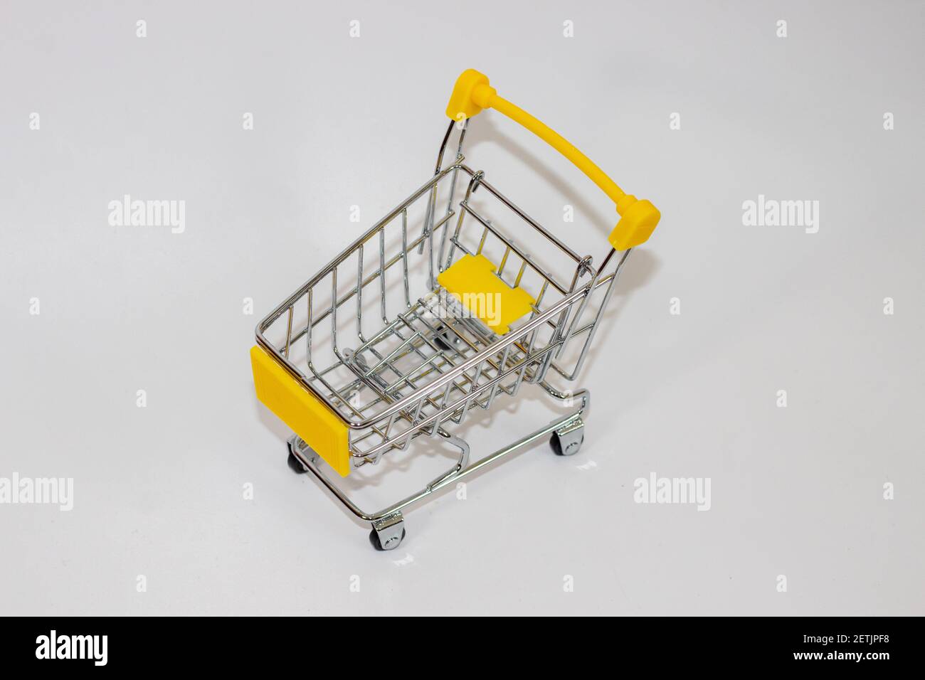 Yellow toy cart on white isolated background Stock Photo - Alamy
