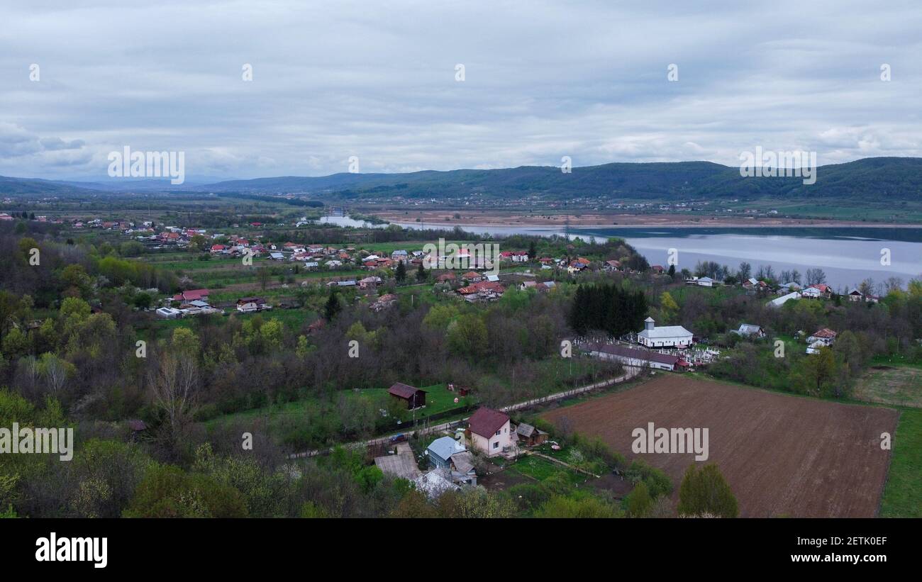 An aerial view of a small waterfront town rural buildings under a rainy ...