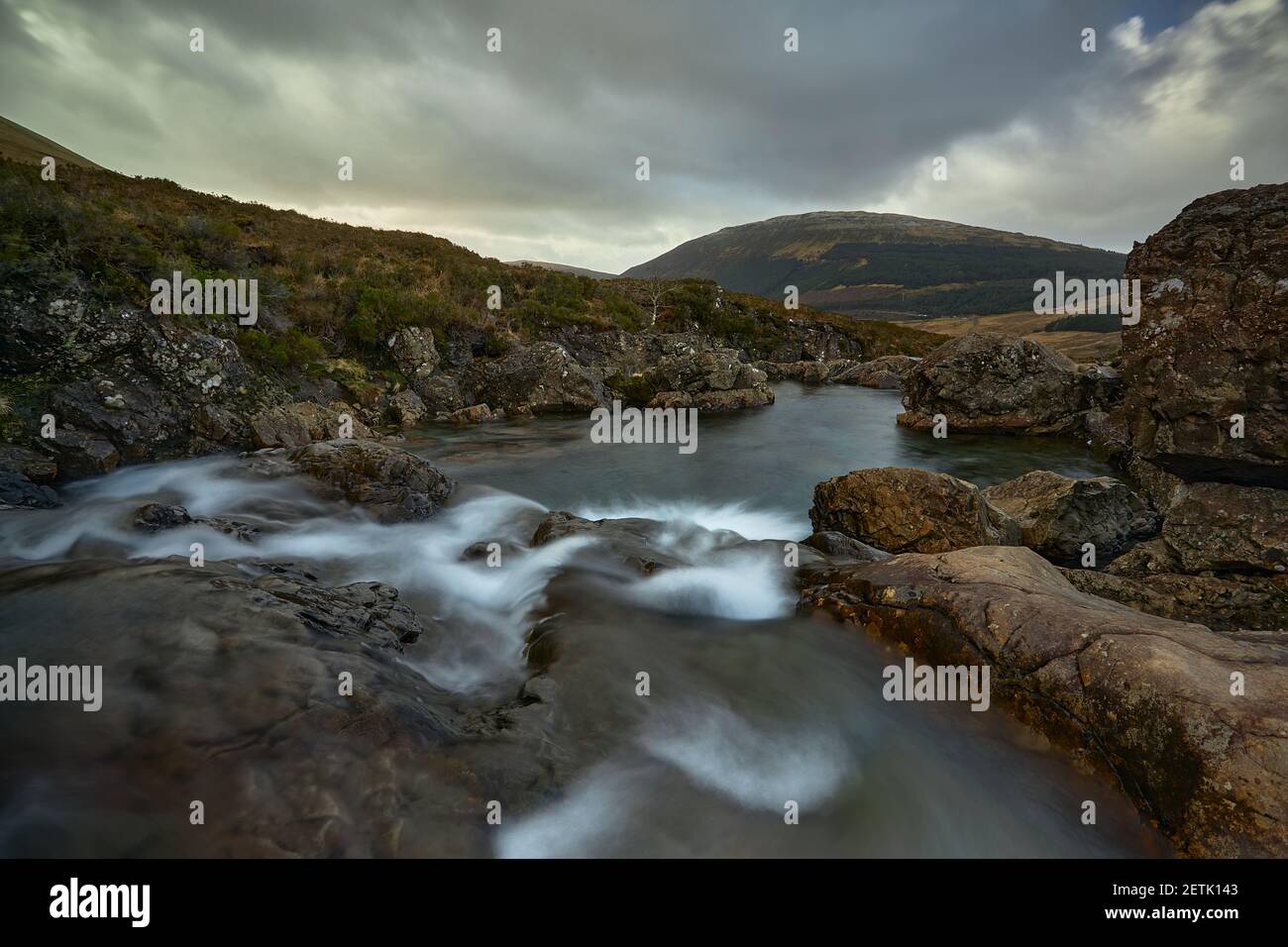 waterfall with silky water towards mountain with cloudy sky- Fairy ...