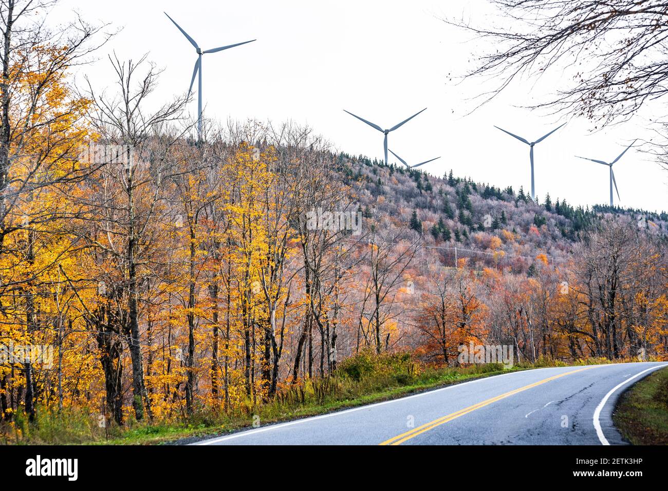 Winding Vermont highway road with wind power generators and autumn ...