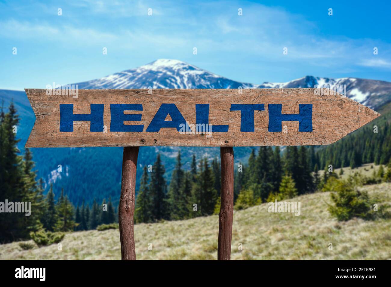 Health wooden arrow road sign against mountains landscape Stock Photo ...