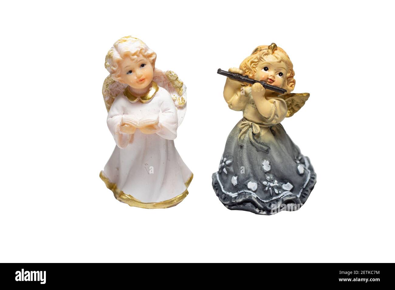 Angel figurines of a girl with a flute and a boy isolated on a white ...