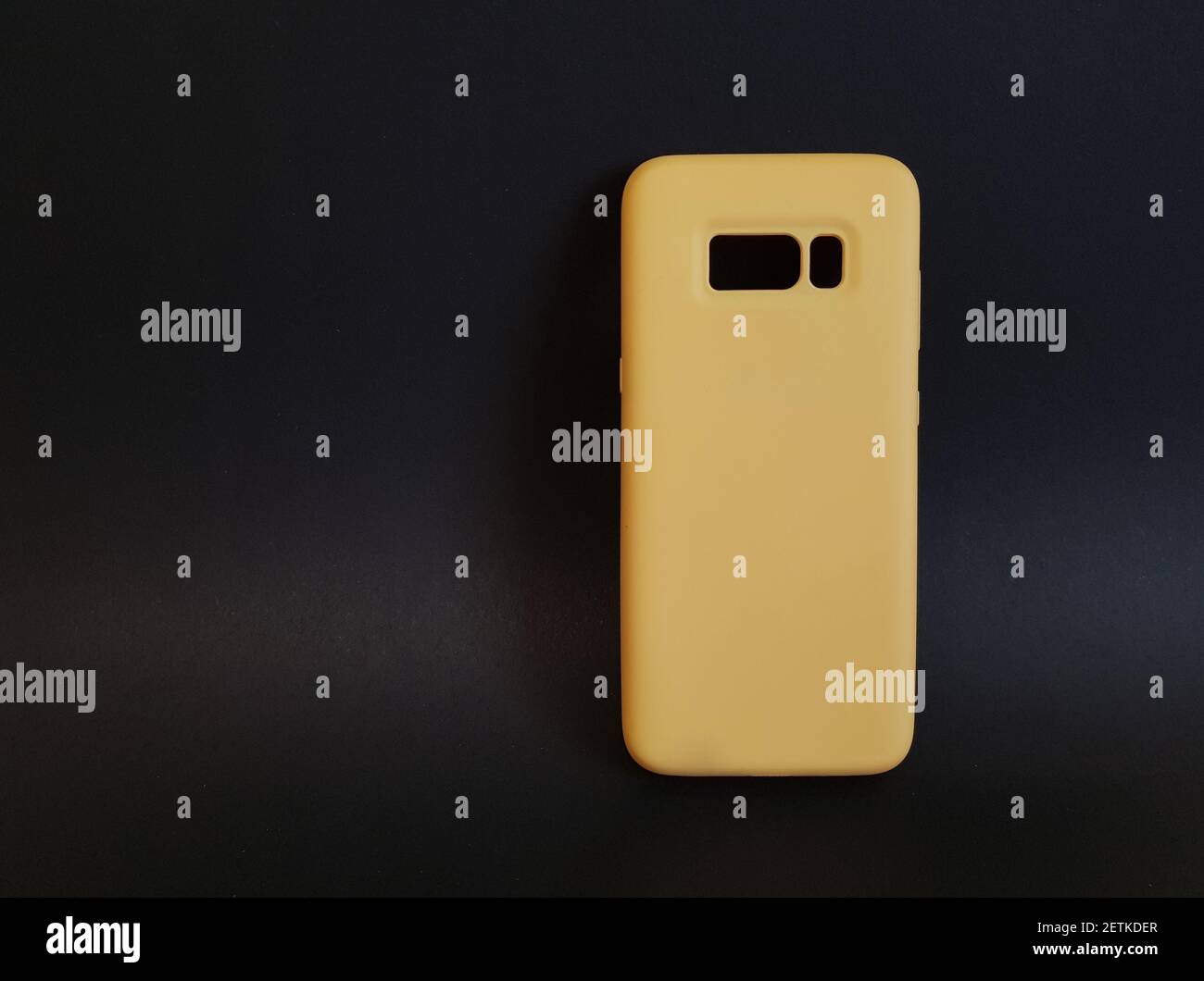 Yellow case on a black isolated background Stock Photo - Alamy