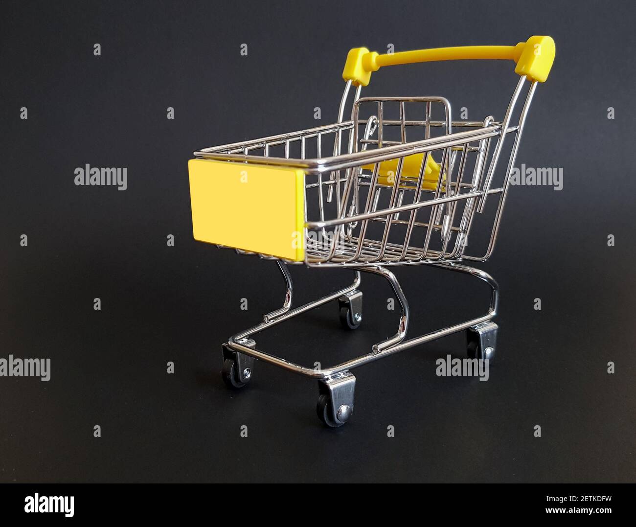 Yellow toy cart on black isolated background Stock Photo - Alamy
