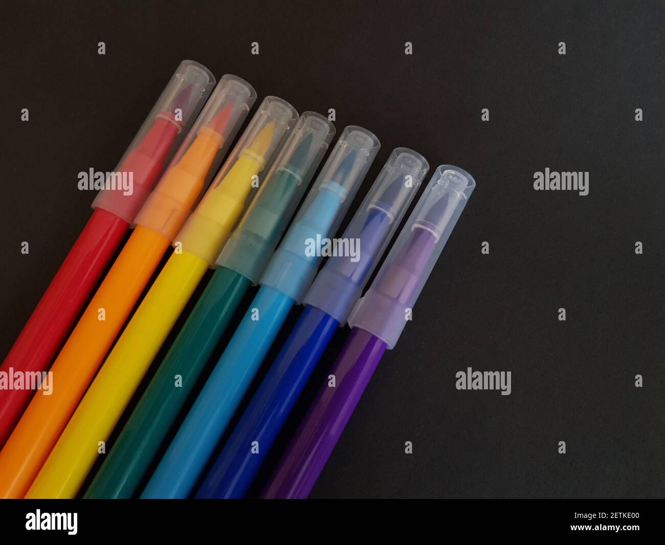 Multi-colored markers for drawing. Markers on a black isolated ...