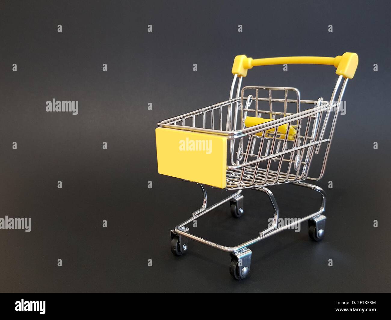 Yellow toy cart on black isolated background Stock Photo - Alamy
