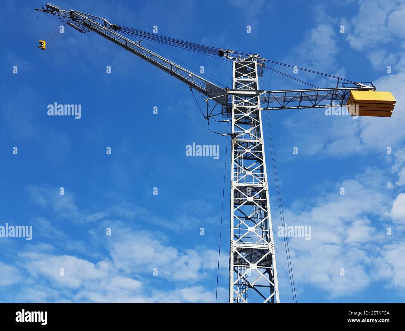 Tower crane for transporting heavy loads against the sky Stock Photo ...