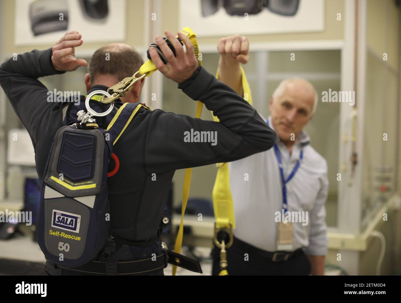 Steve Kosch demonstrates a construction worker safety harness with ...