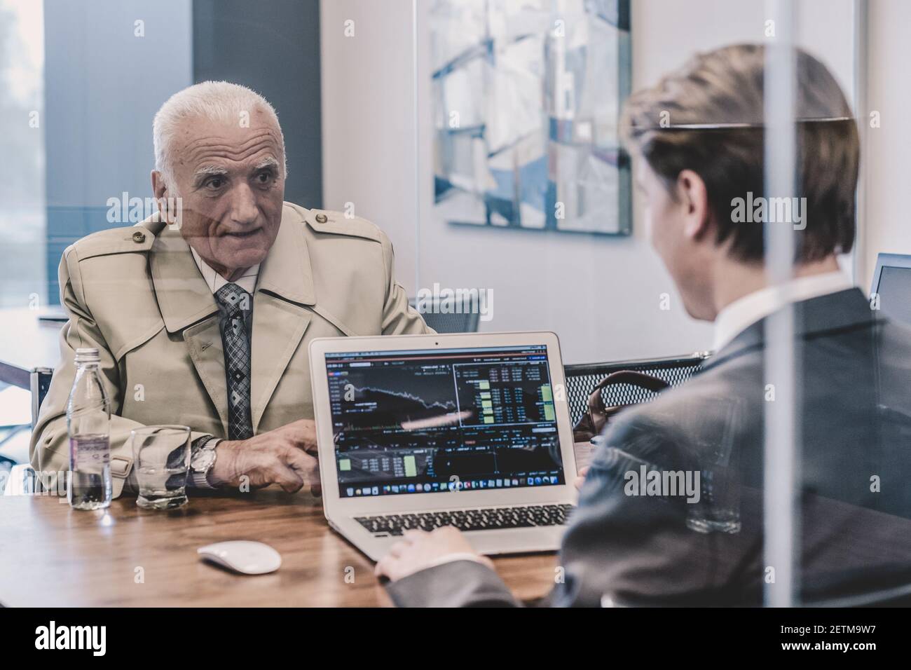 Financial advisor consulting senior client with his investment strategy ...