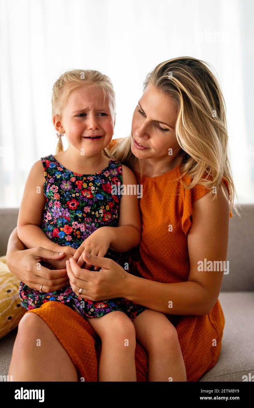 Mother comforting her crying little girl. Parenthood, family support ...