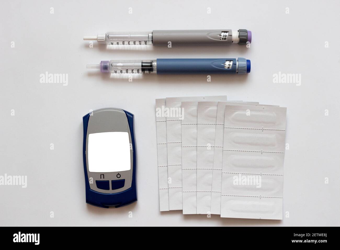 Insulin short, long, glucose meter and test strips on a white isolated ...