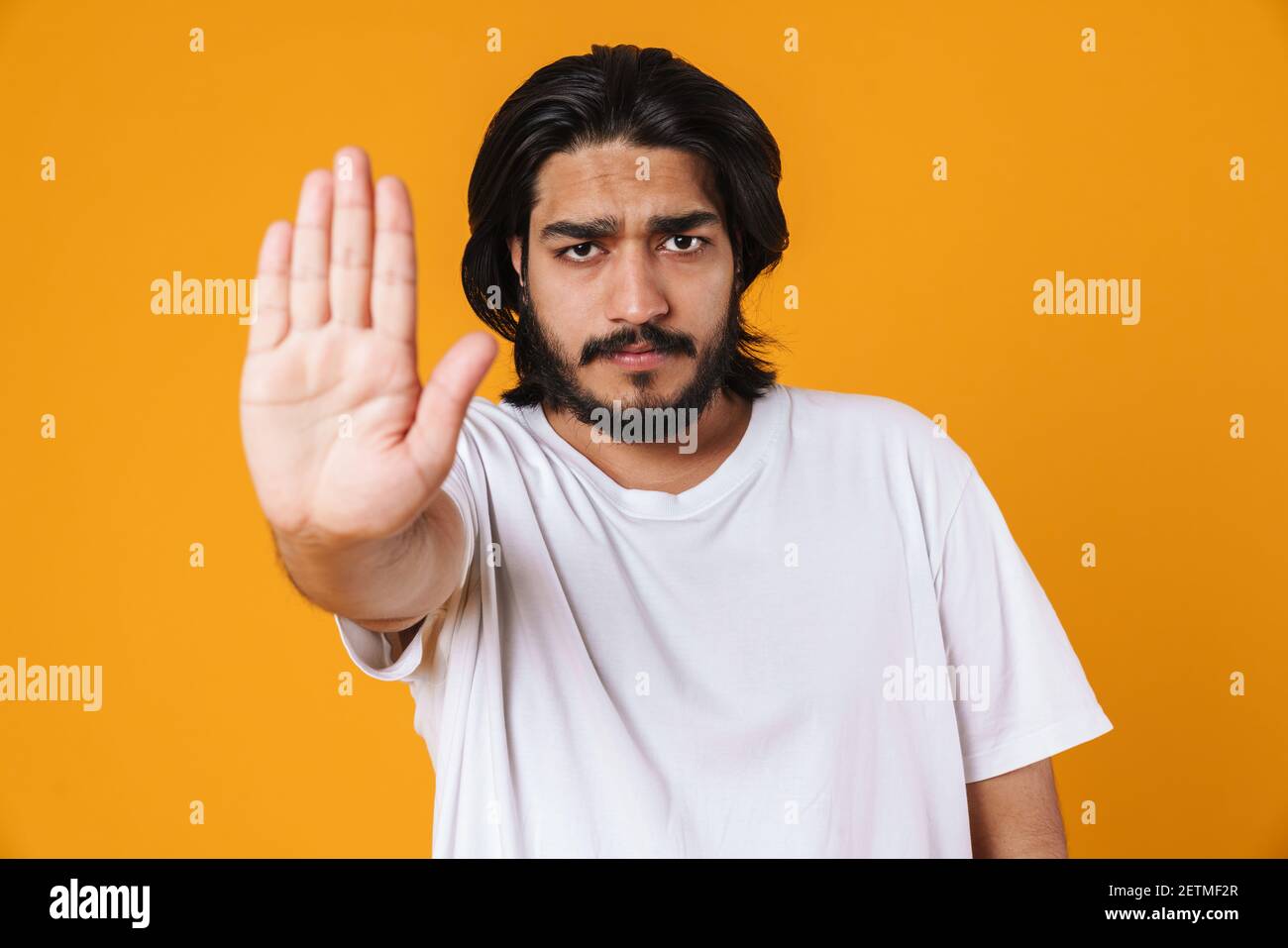 Upset young indian man showing denial gesture isolated over yellow ...
