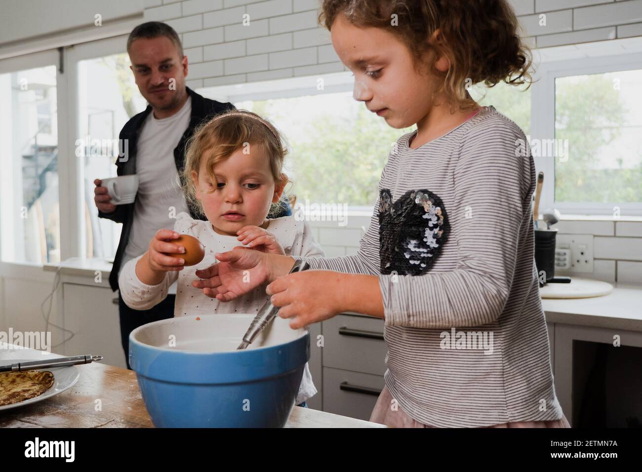 Two sisters cooking together hi-res stock photography and images - Alamy