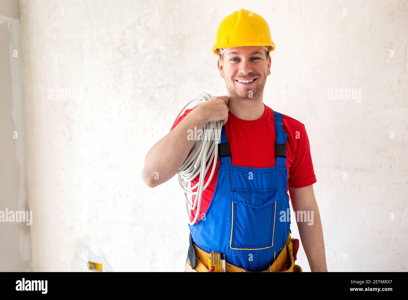 Electric cable placement on a working site performed by a handyman ...