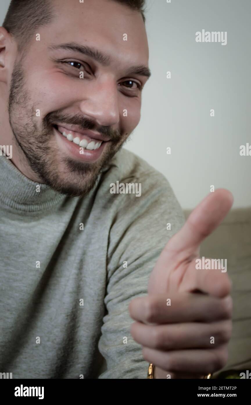 Portrait of a young man with a short beard speaks gesturing with his ...
