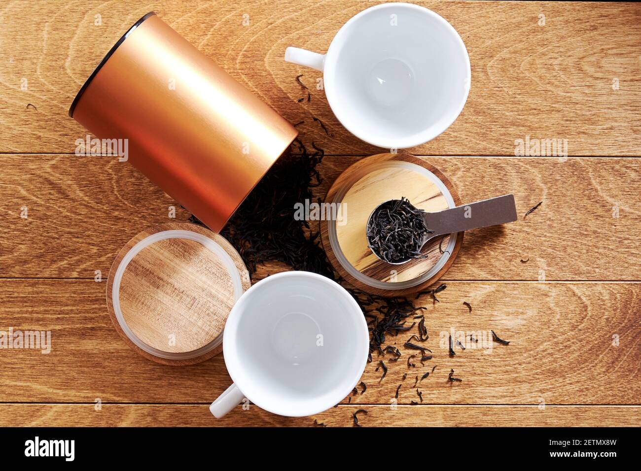 Black tea brew with cups, jar and spoon prepared for breakfast on the ...