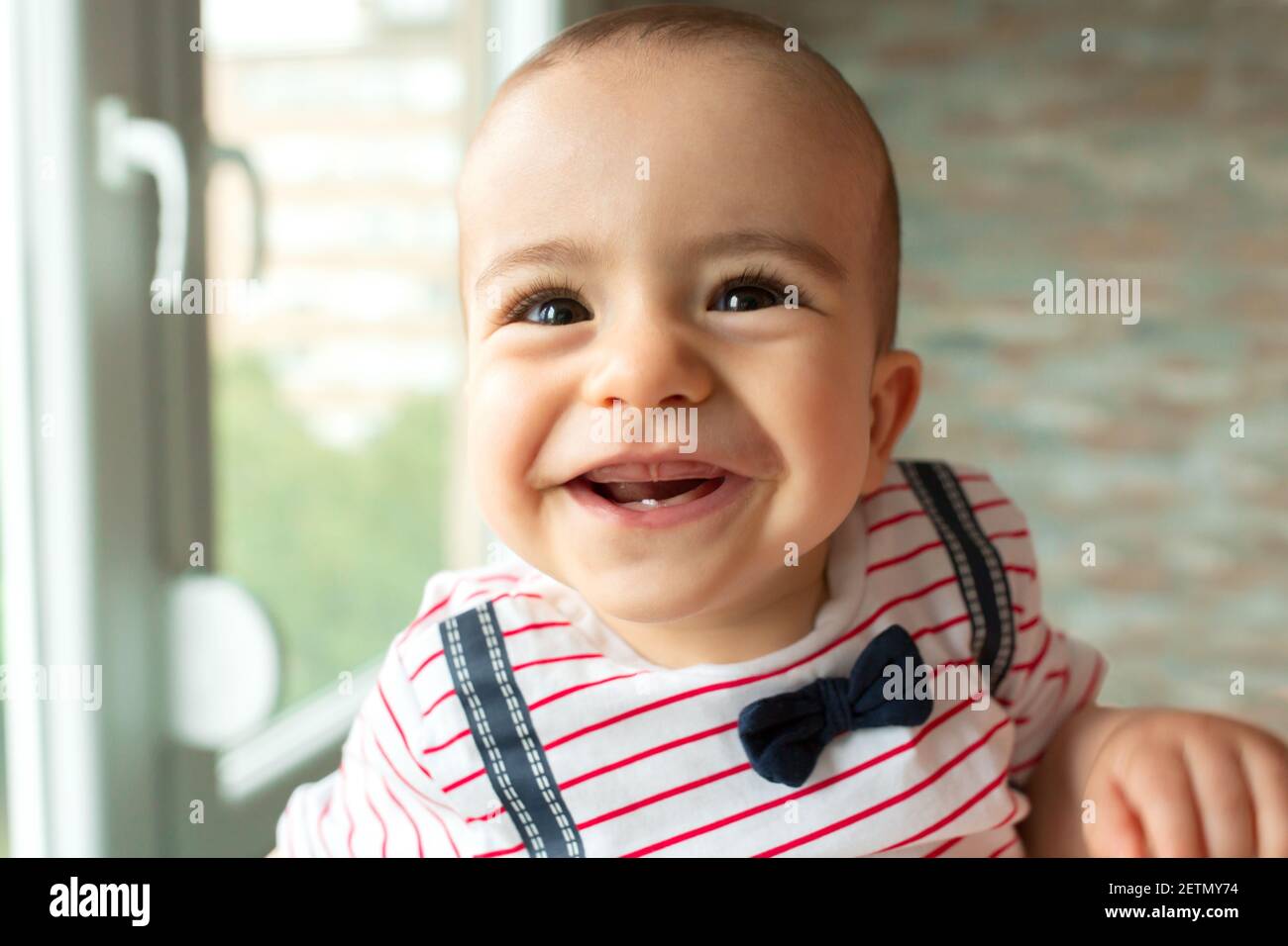 Just a cute baby smiling and laughing at the camera with innocence in ...