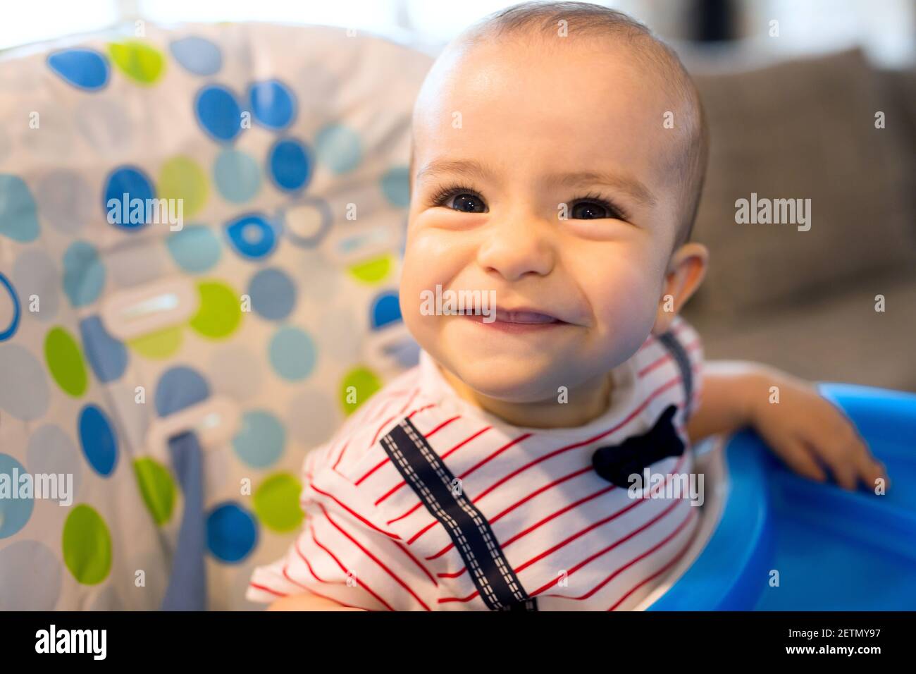 Just a cute baby smiling and laughing at the camera with innocence in ...