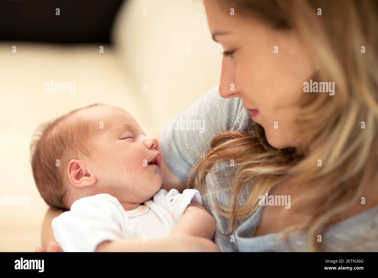 Careless child sleeping tight in her mother arms while bonding and ...