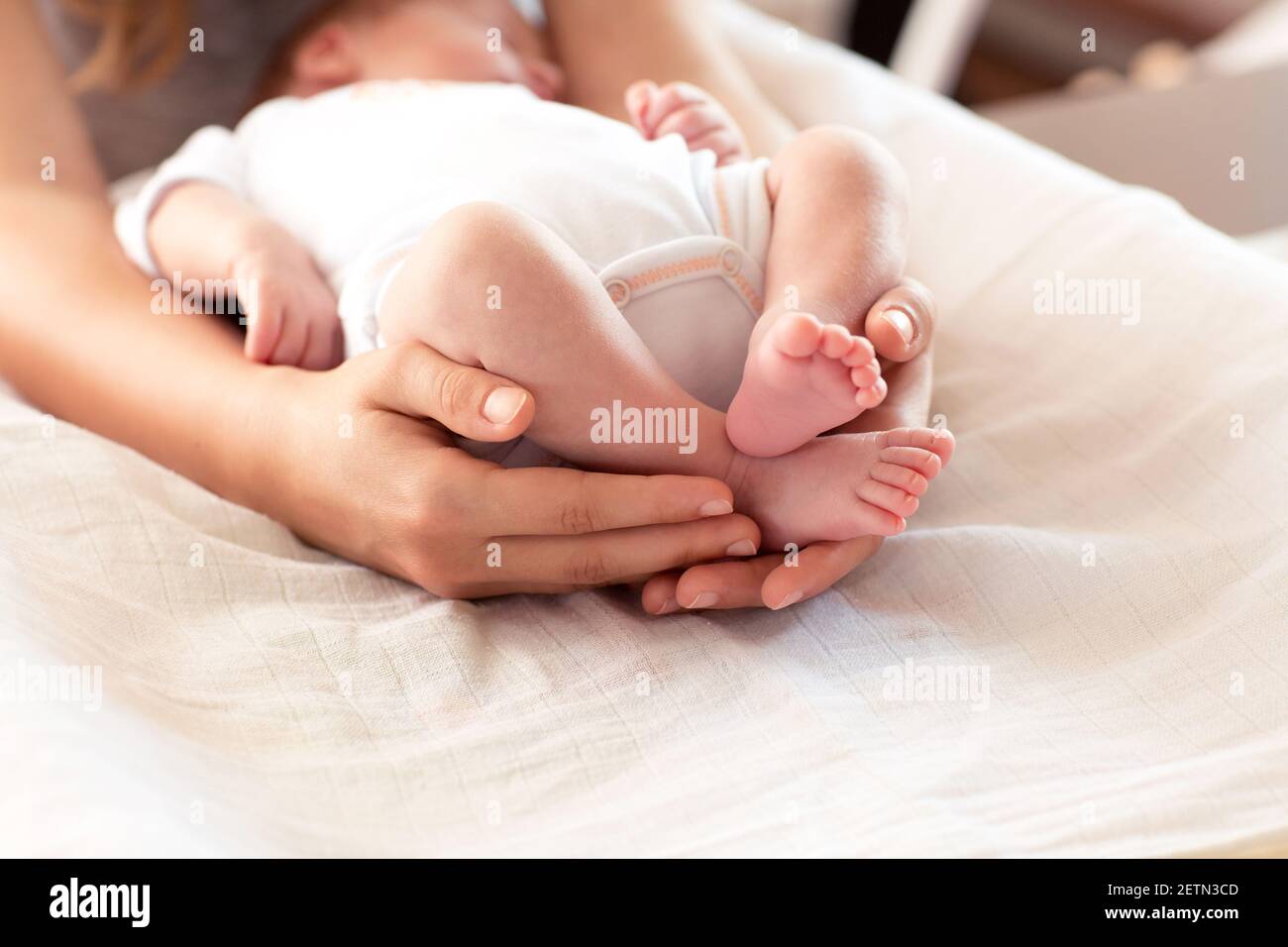 Soft baby skin and gentle hands of her mother holding the child with ...