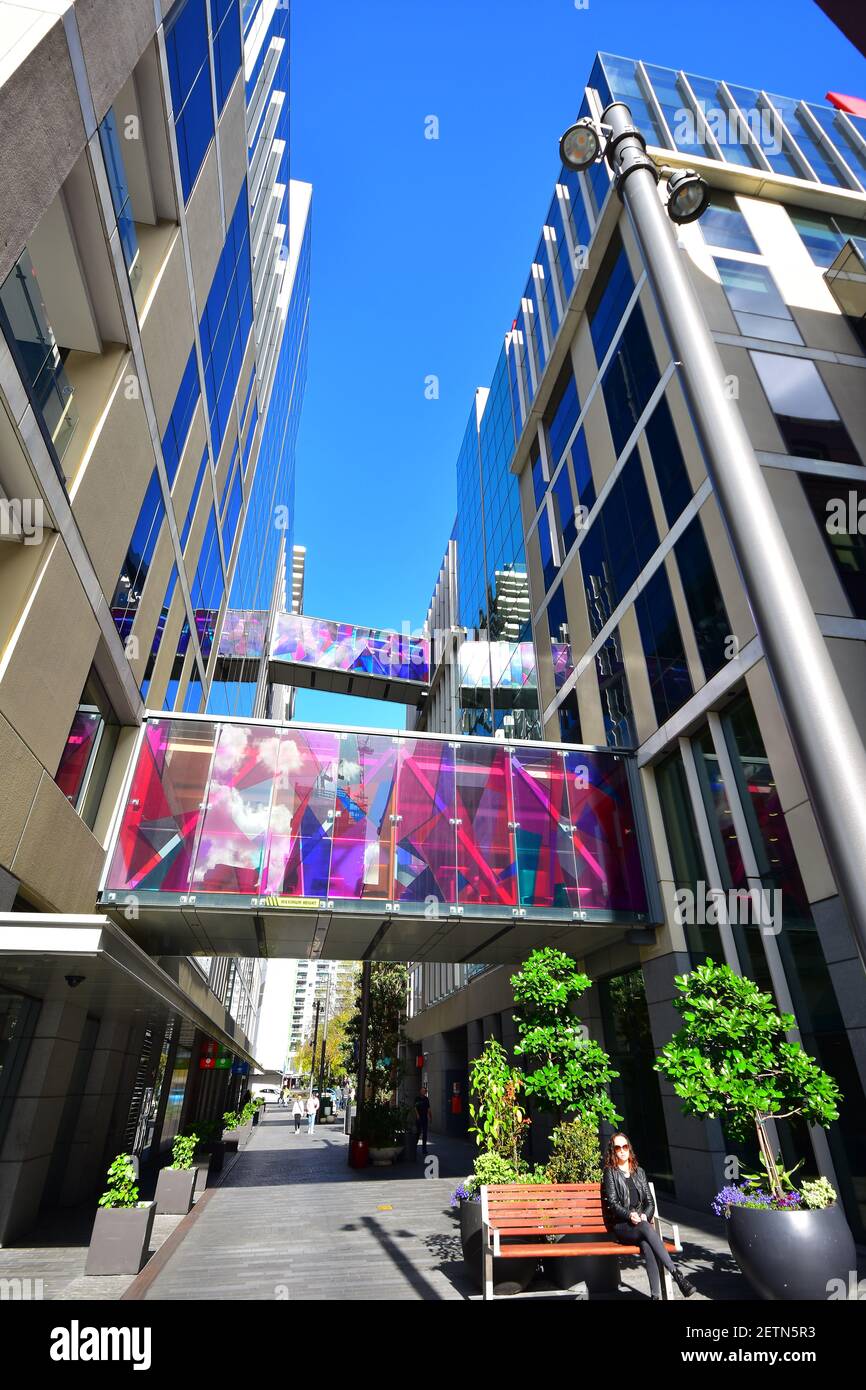 Multi storey apartment buildings connected via colourful bridges with ...