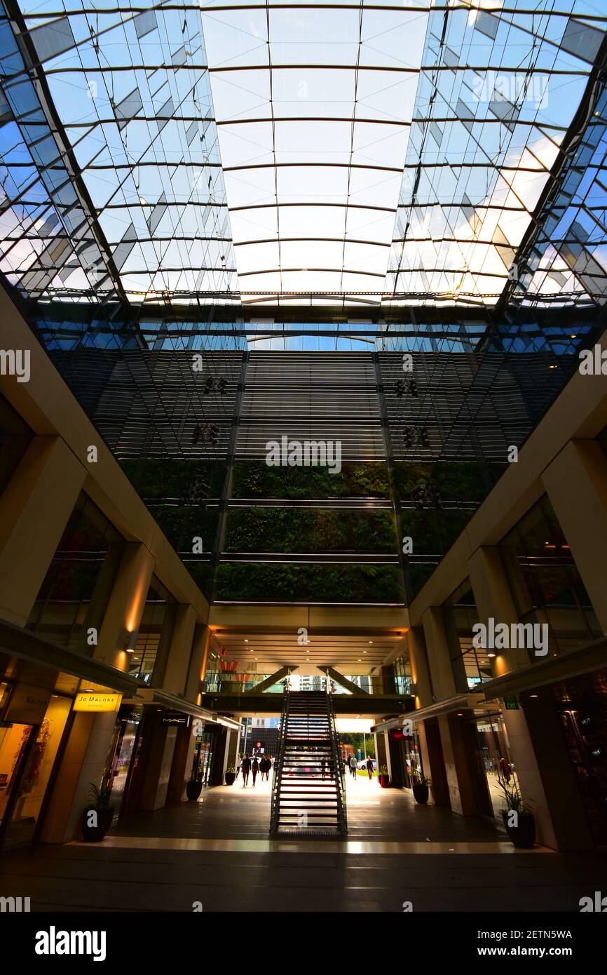 Modern high rise building with glass ceiling and central interior ...