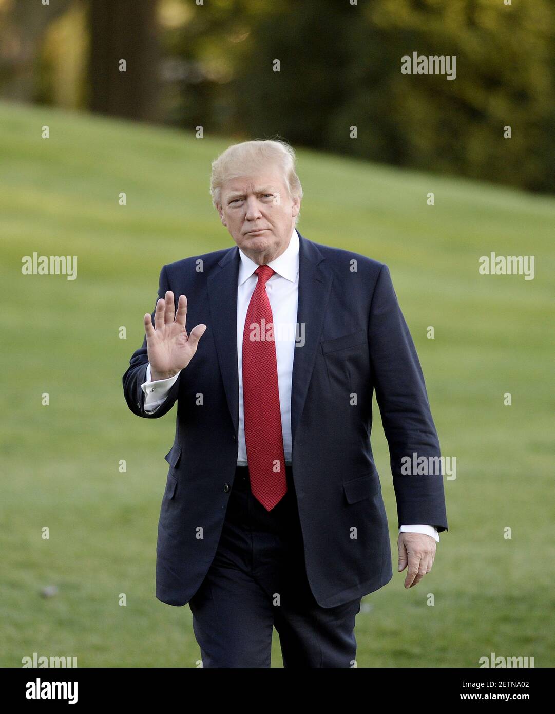 US President Donald Trump walks on the south Lawn after arriving at the ...