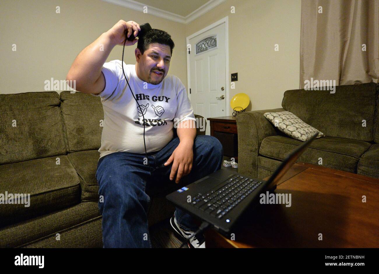 Richard Lopez Jr., of Tracy, who has epilepsy, uses a monitor that is ...