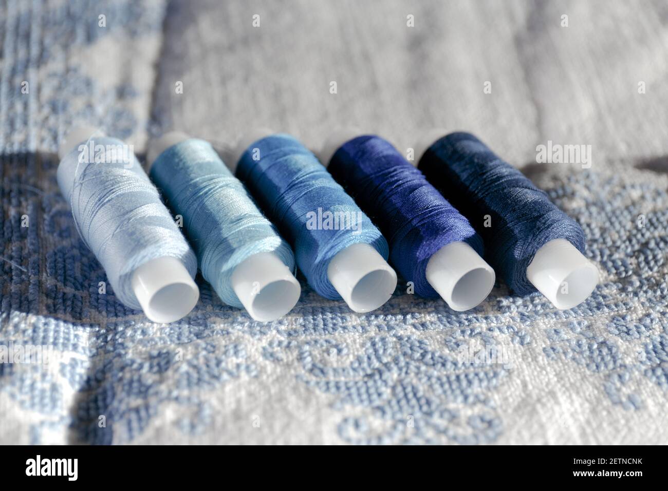 Blue threads. Set of sewing thread coils. Close-up of several bobbins ...