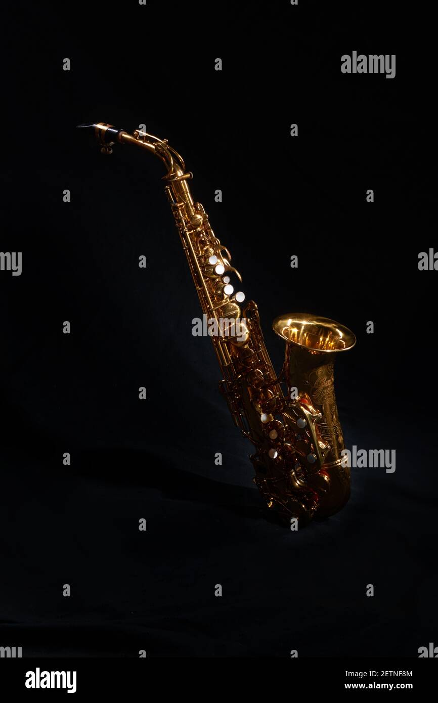 Alto Saxophone upright on black background uk Stock Photo - Alamy