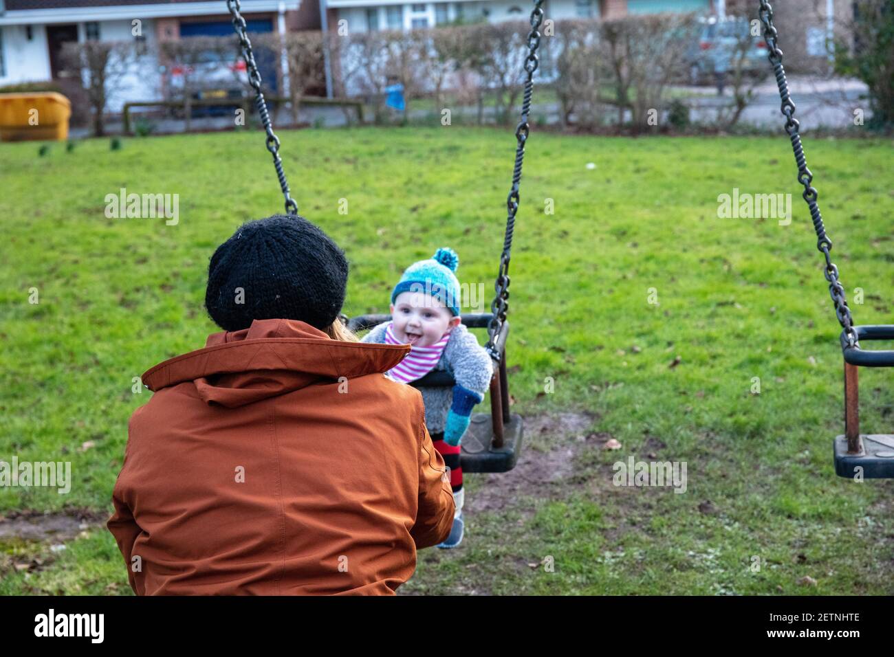 Caucasian Baby boy on the swing with mother in winter Stock Photo - Alamy
