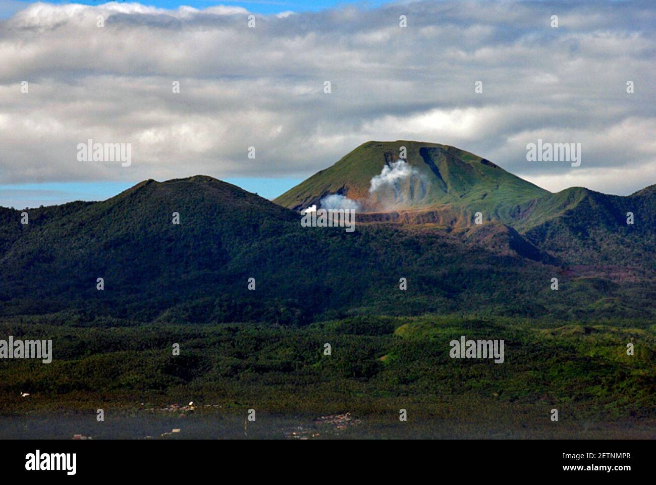 Mount Lokon volcano is photographed from Bunaken Island in Manado ...