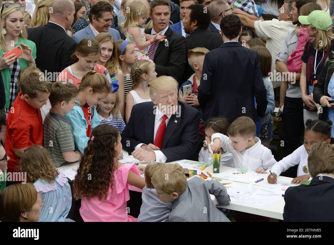 US President Donald Trump makes cards for members of the military at ...
