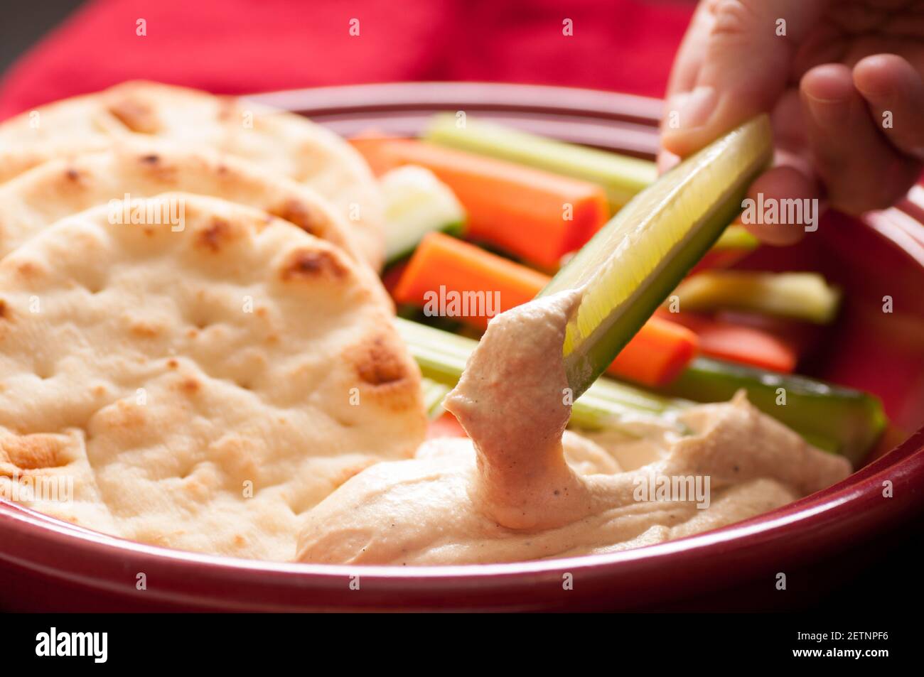 home made hummus or hummous with naan bread and vegetable sticks Stock ...