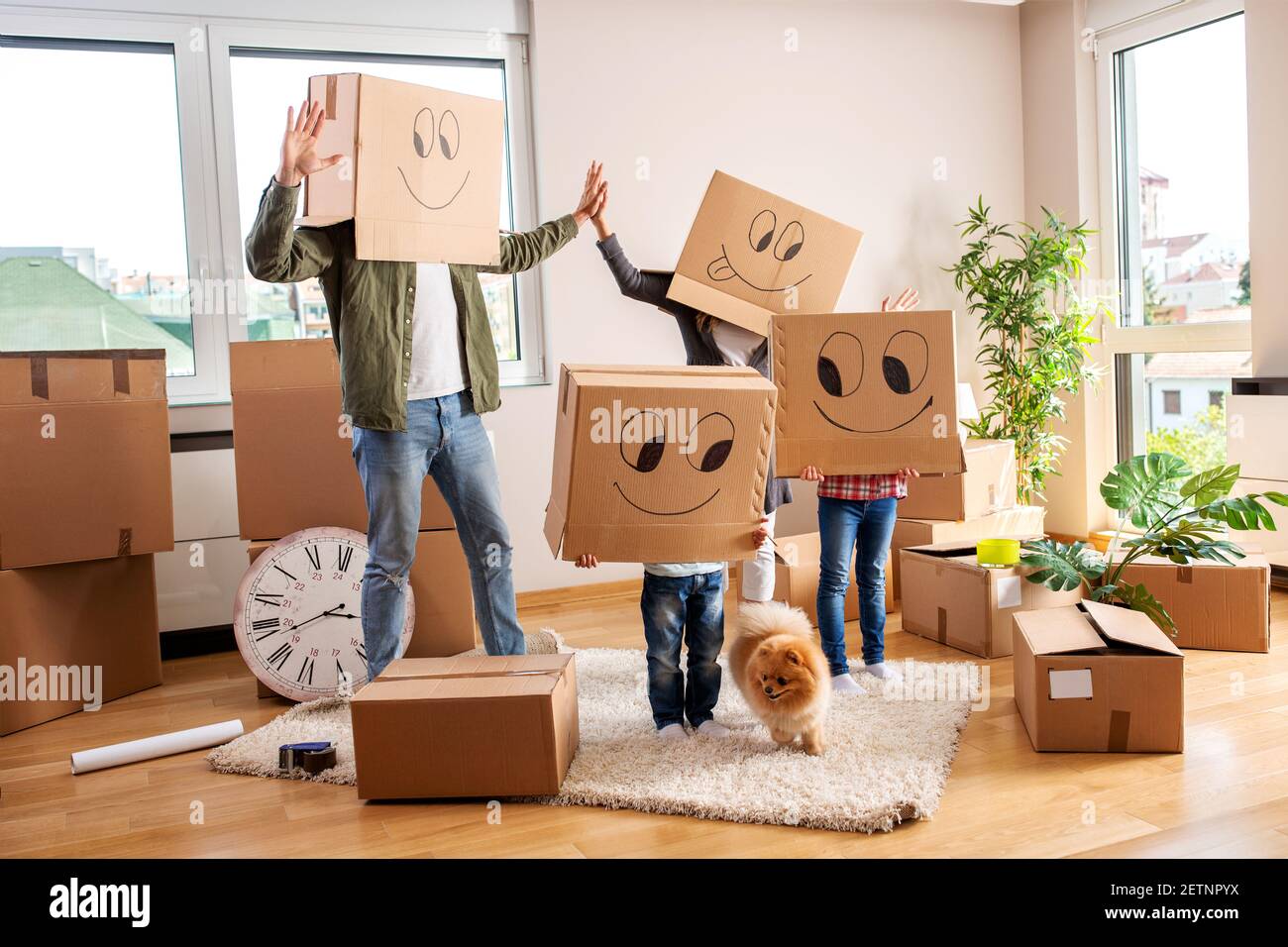 Moving in family party with boxes, fun and party unpacking time Stock ...