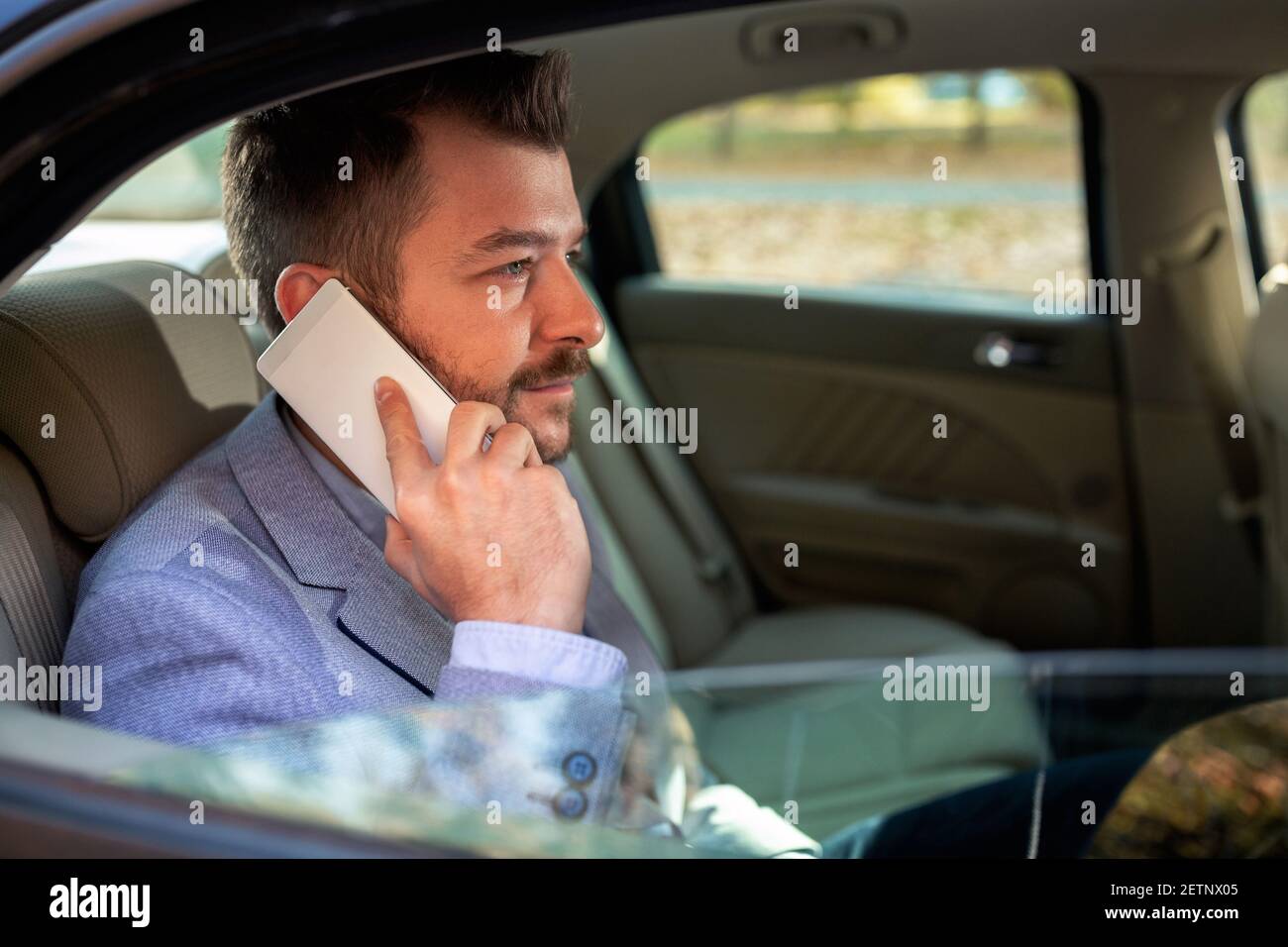 An executive person on his way to work, driving in the car Stock Photo ...
